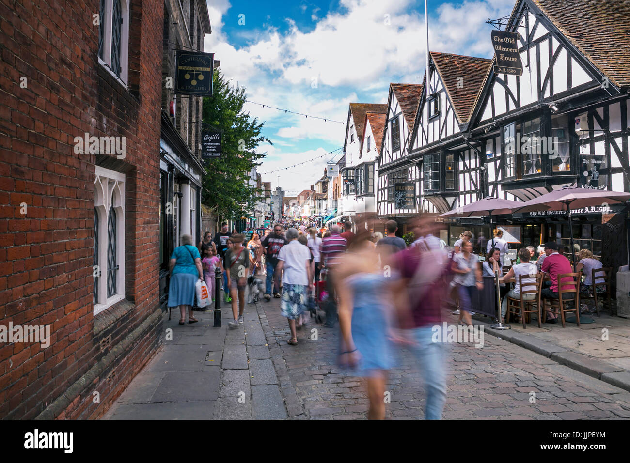 People walking in a cobbled medieval high street Stock Photo - Alamy