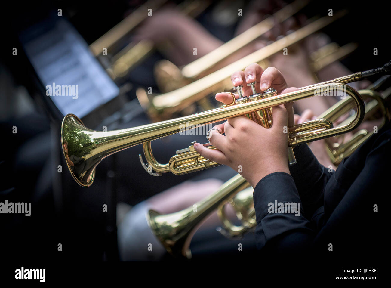 A trumpet player in a band performs at Trebah Gardens amphitheatre in ...