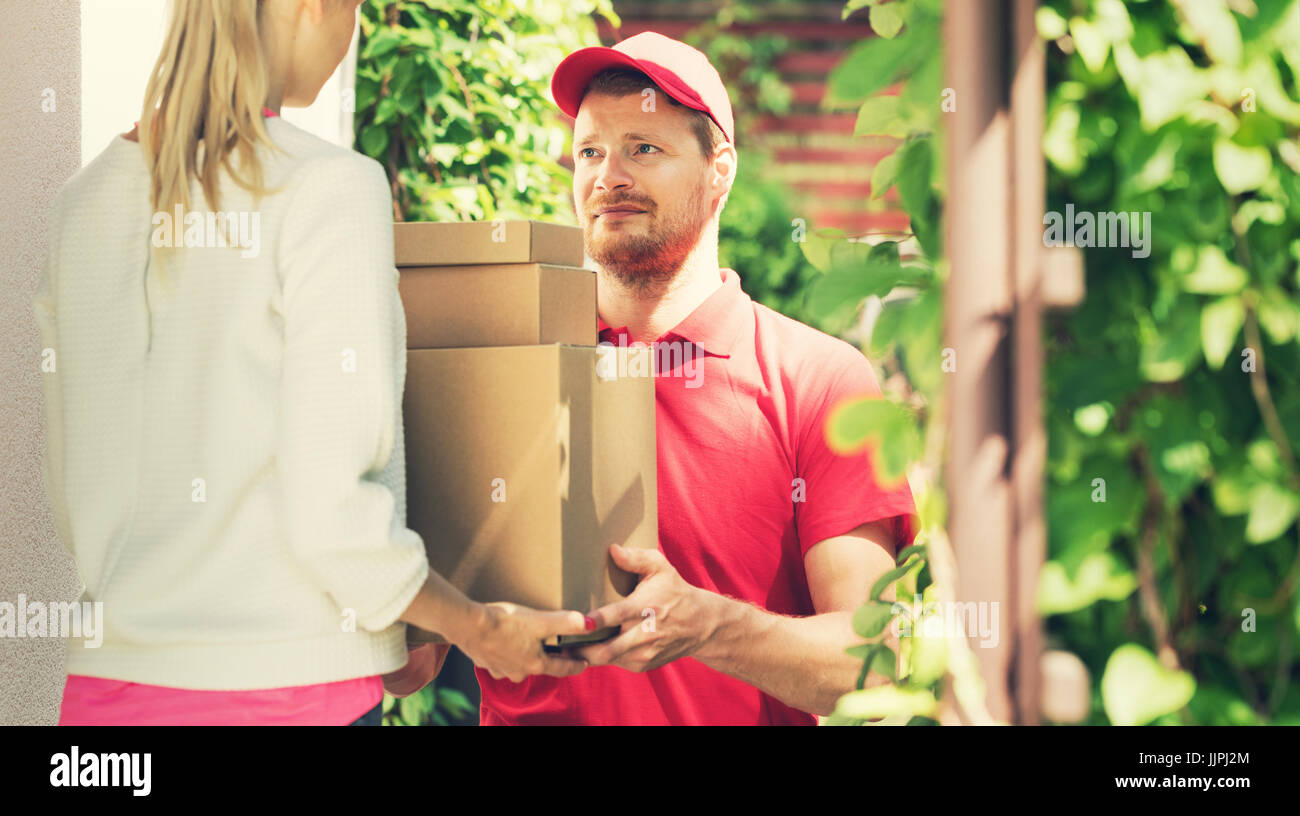 woman accepting a home delivery of boxes from deliveryman. copy space ...