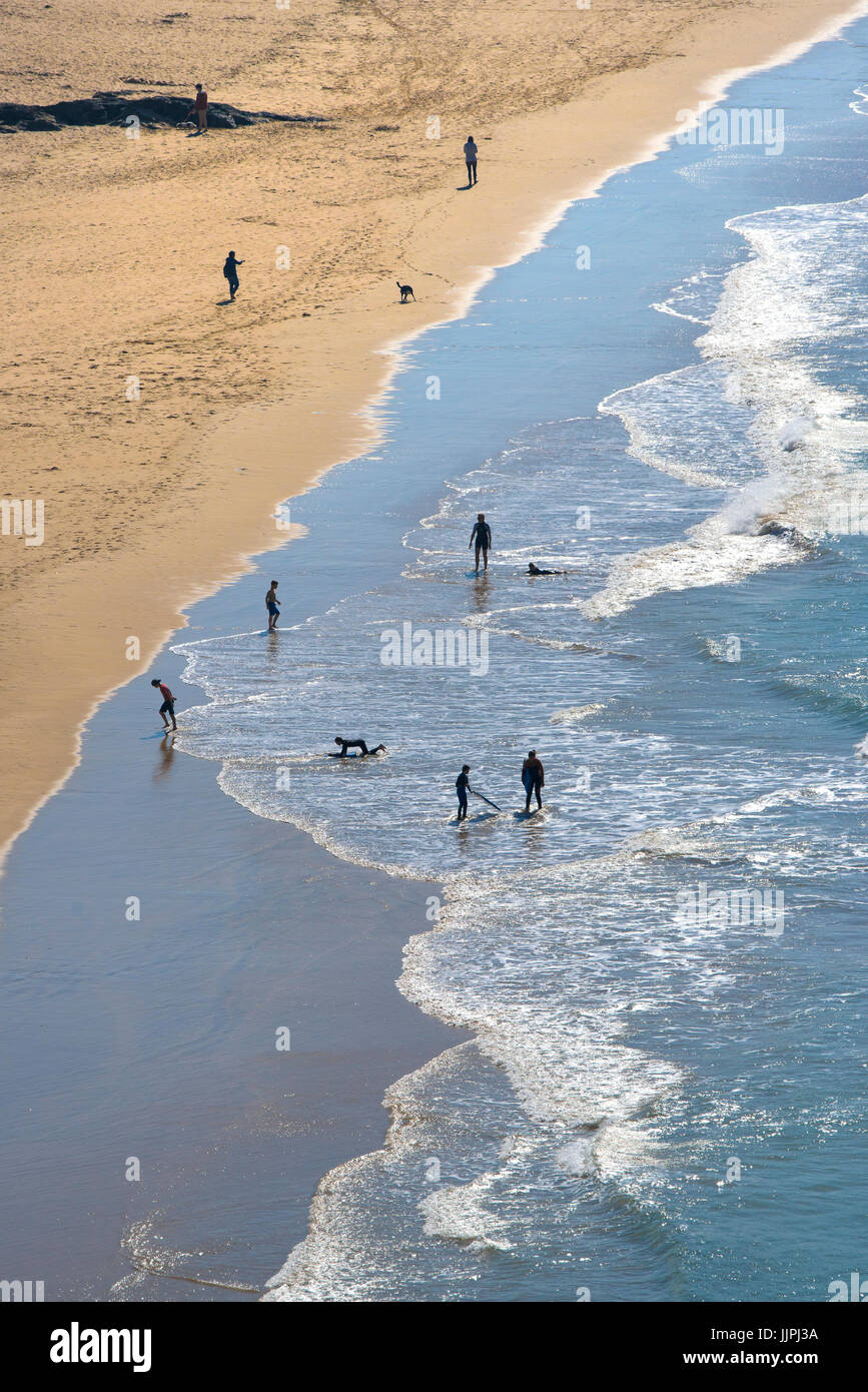 Holidaymakers seen in silhouette on Crantock Beach in Cornwall Stock ...