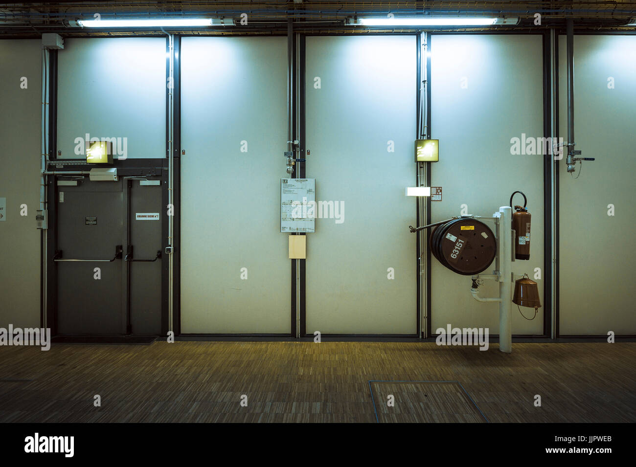 Emergency exit and a fire extinguisher in an industrial building Stock ...