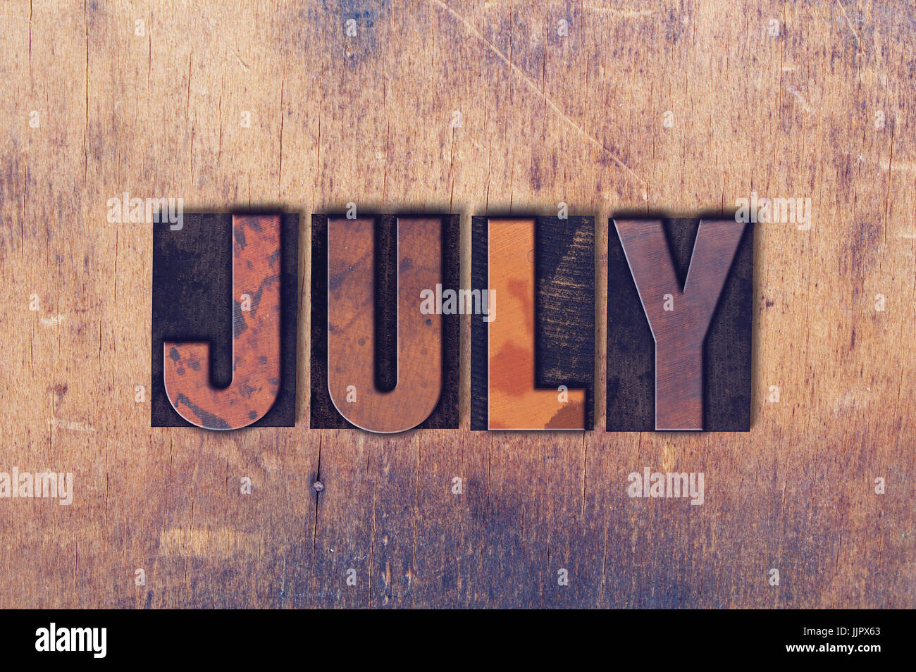 The word July concept and theme written in vintage wooden letterpress ...