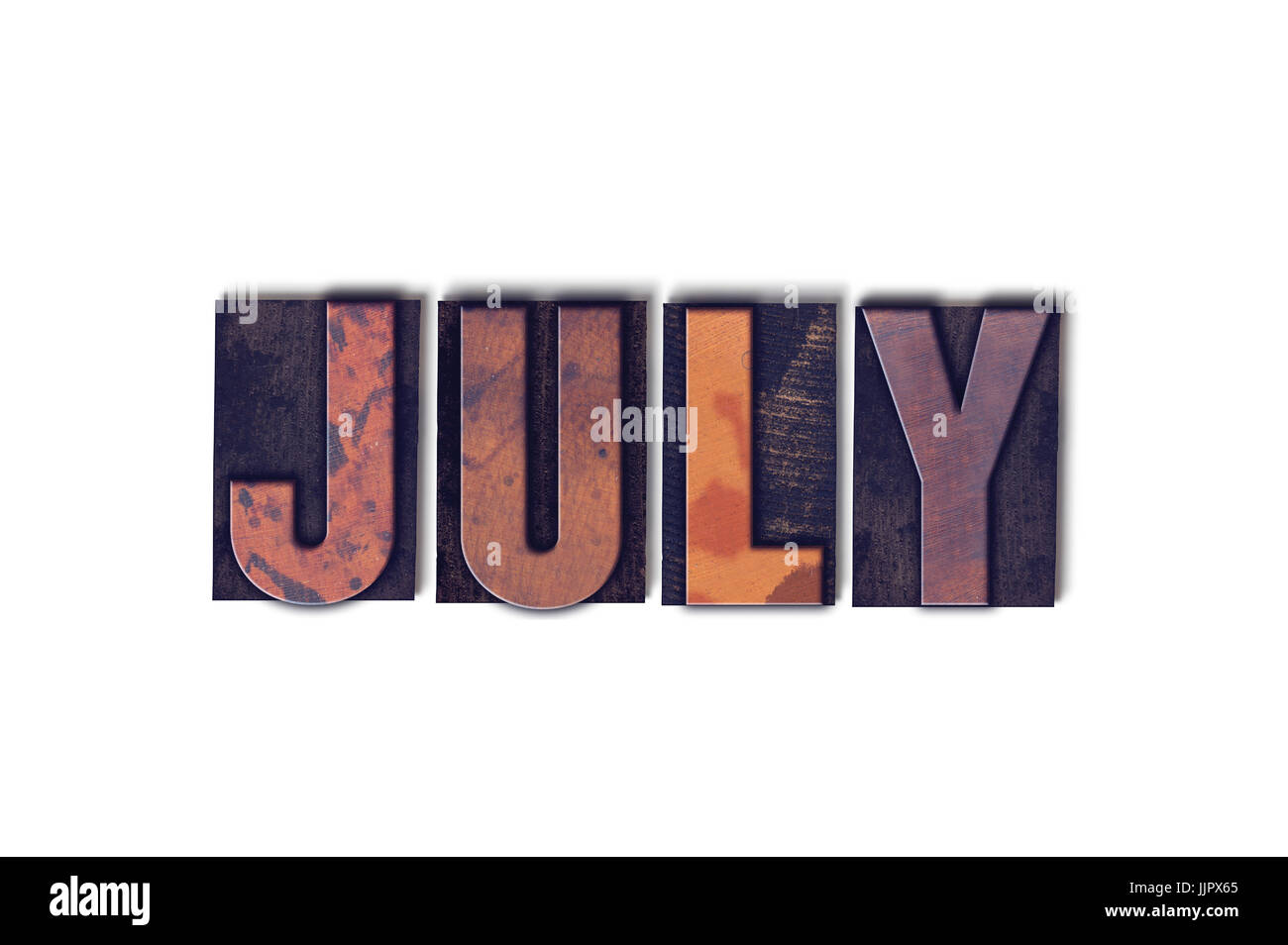 The word July concept and theme written in vintage wooden letterpress ...