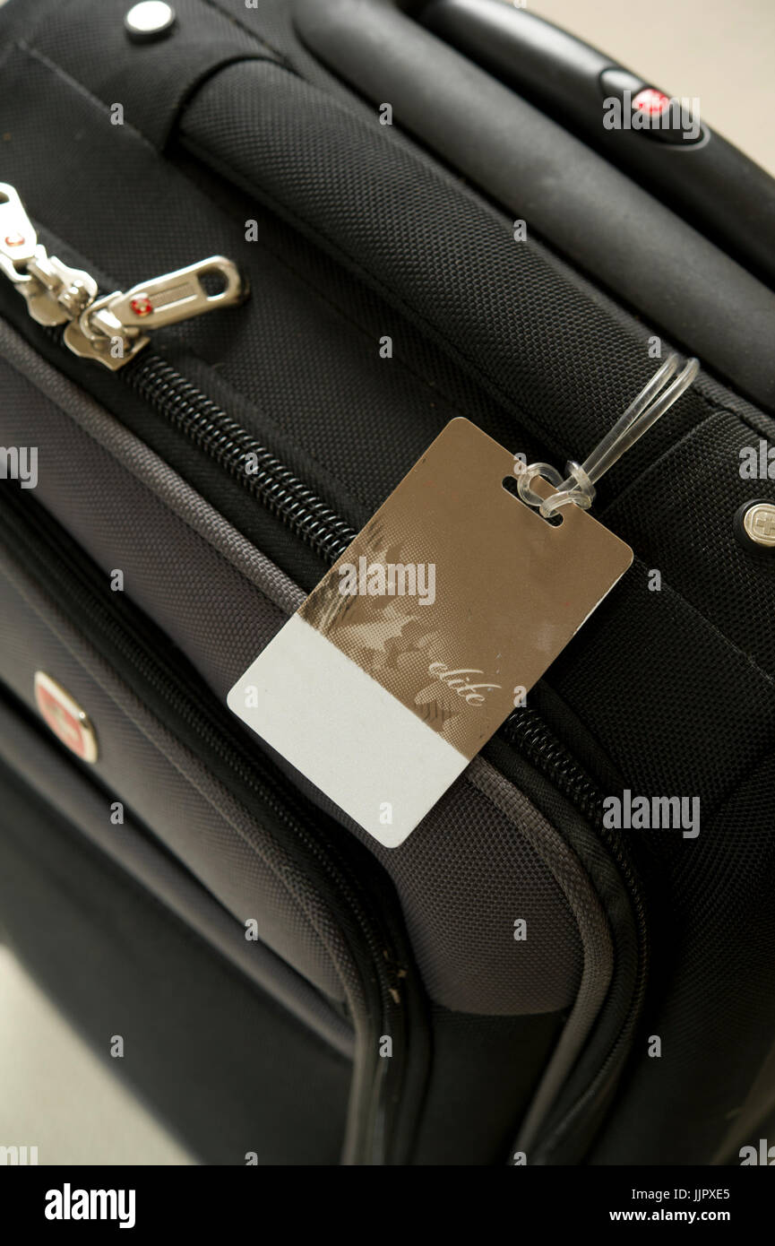 Tag on a handle of a suitcase Stock Photo - Alamy