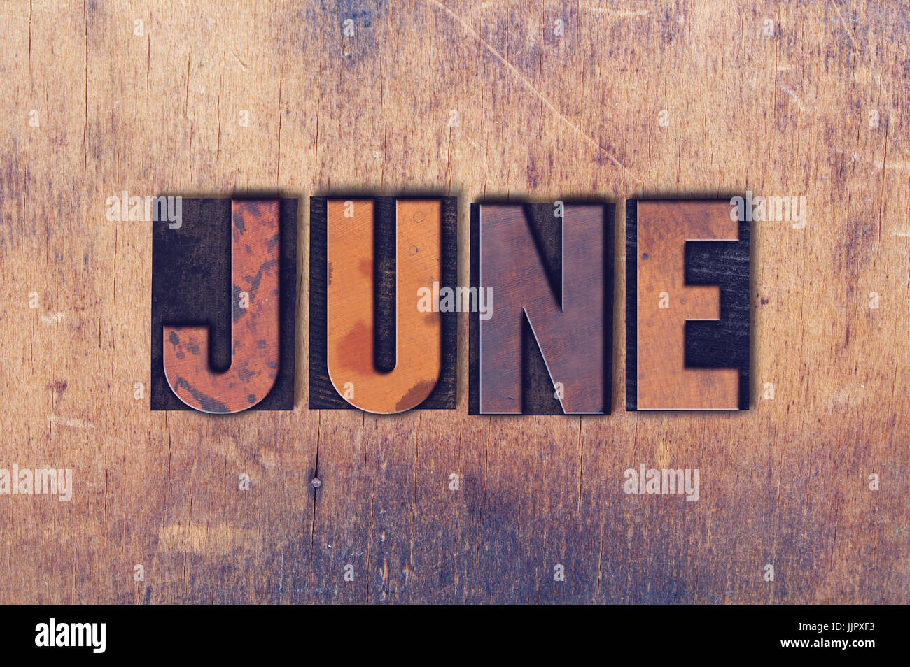 The word June concept and theme written in vintage wooden letterpress ...