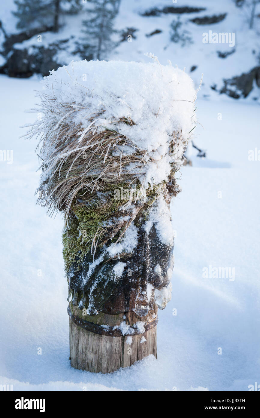 Snow covered wooden pole Stock Photo - Alamy