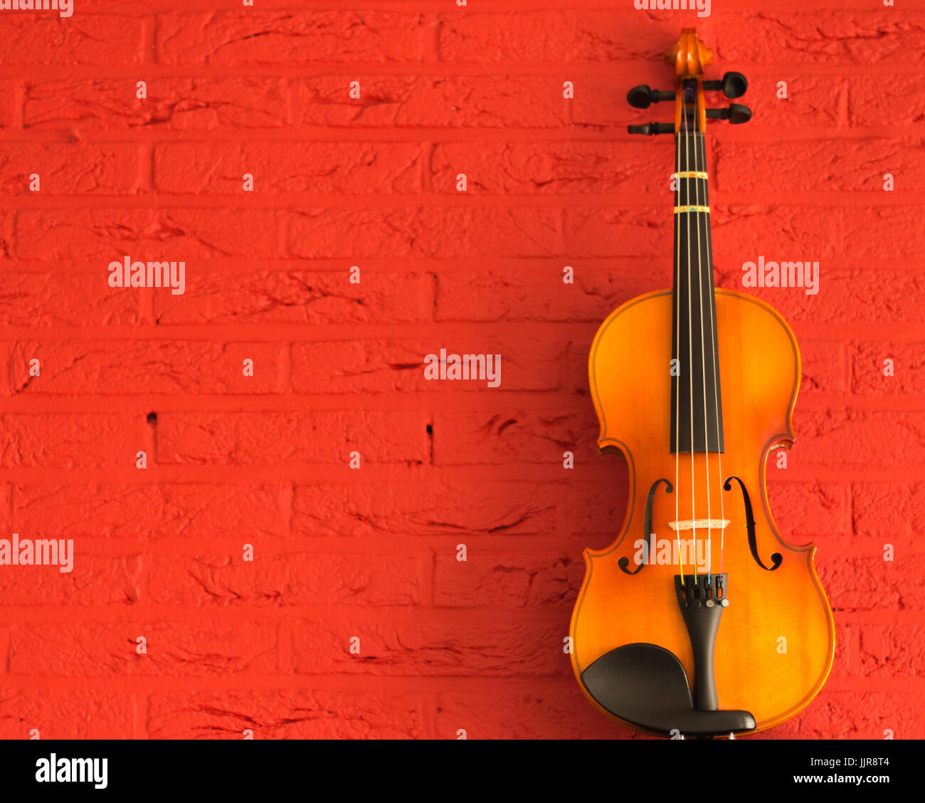 classical violin on a red stone background Stock Photo - Alamy