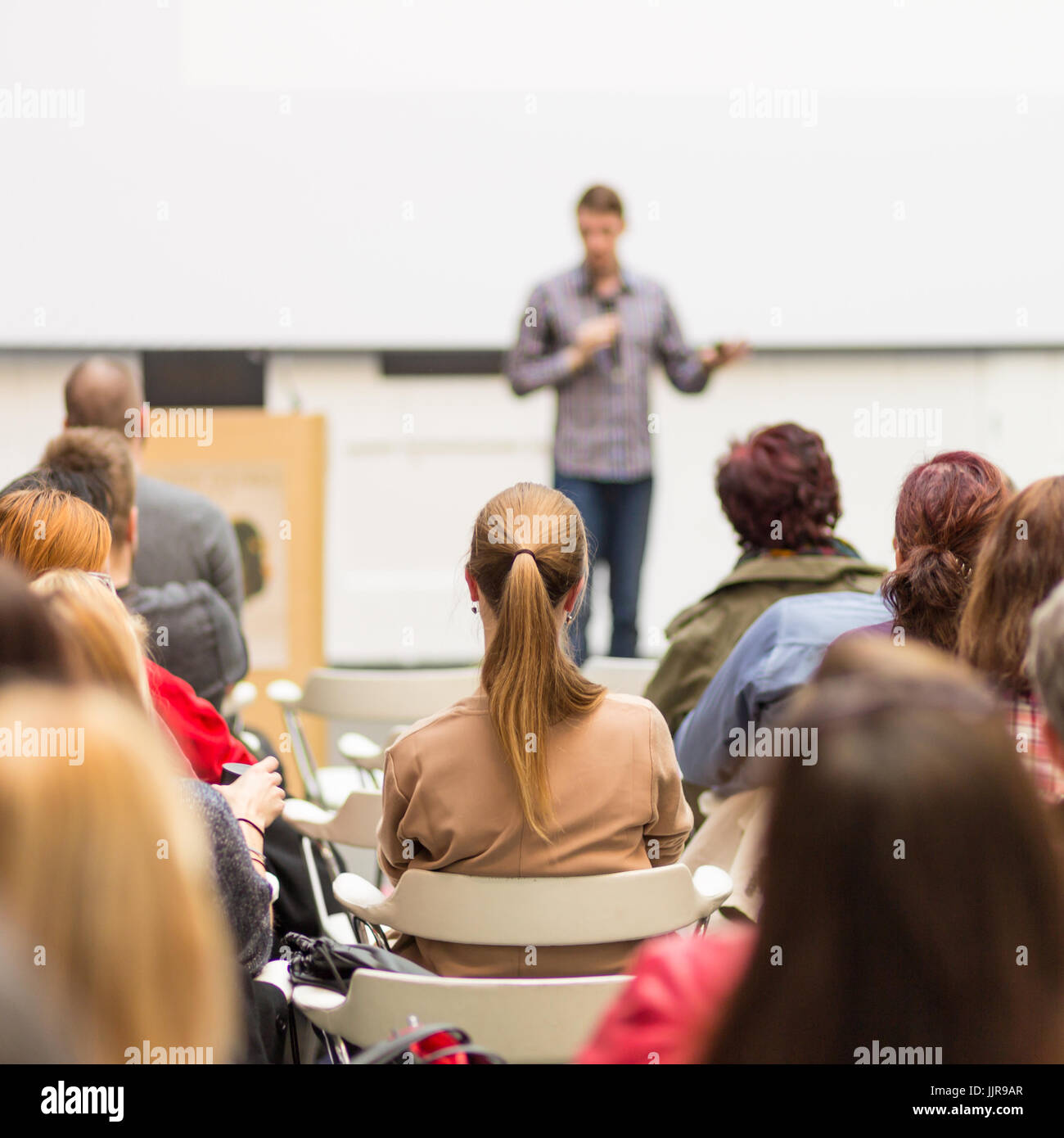 Man giving presentation in lecture hall at university Stock Photo - Alamy
