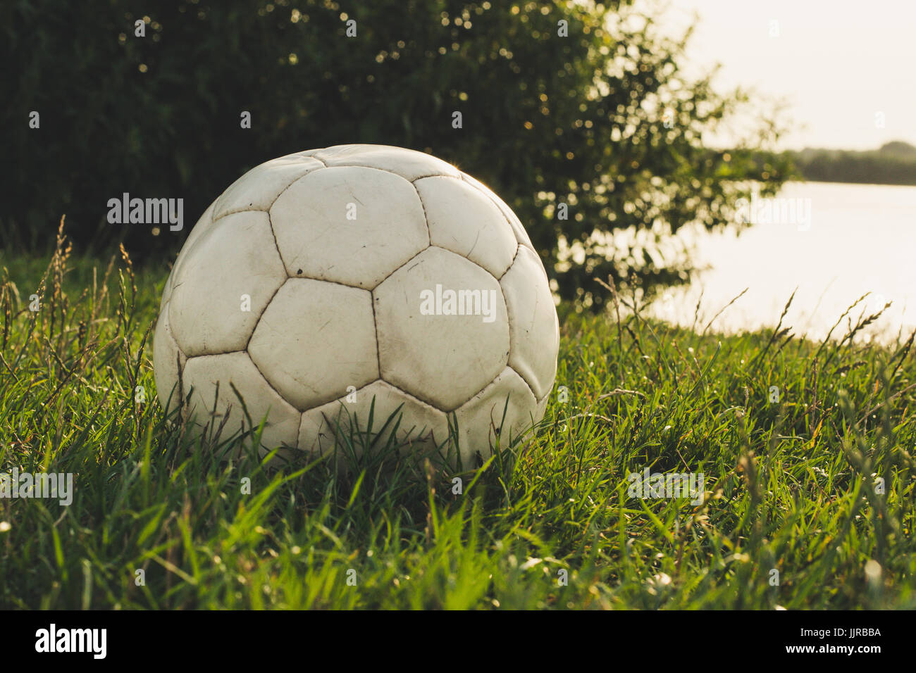 Ball in the grass Stock Photo - Alamy