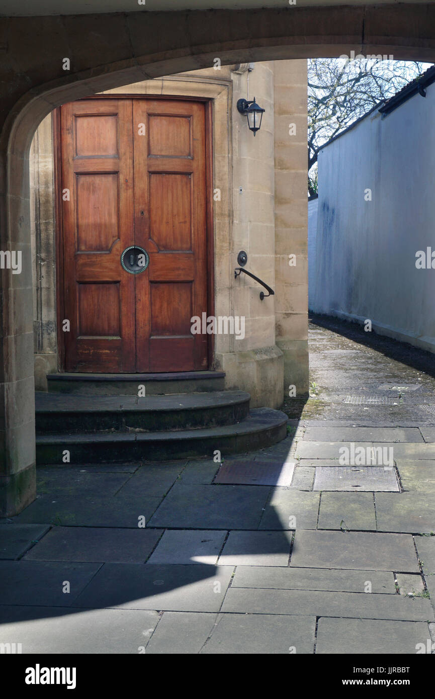 wooden door underneath archway Stock Photo - Alamy