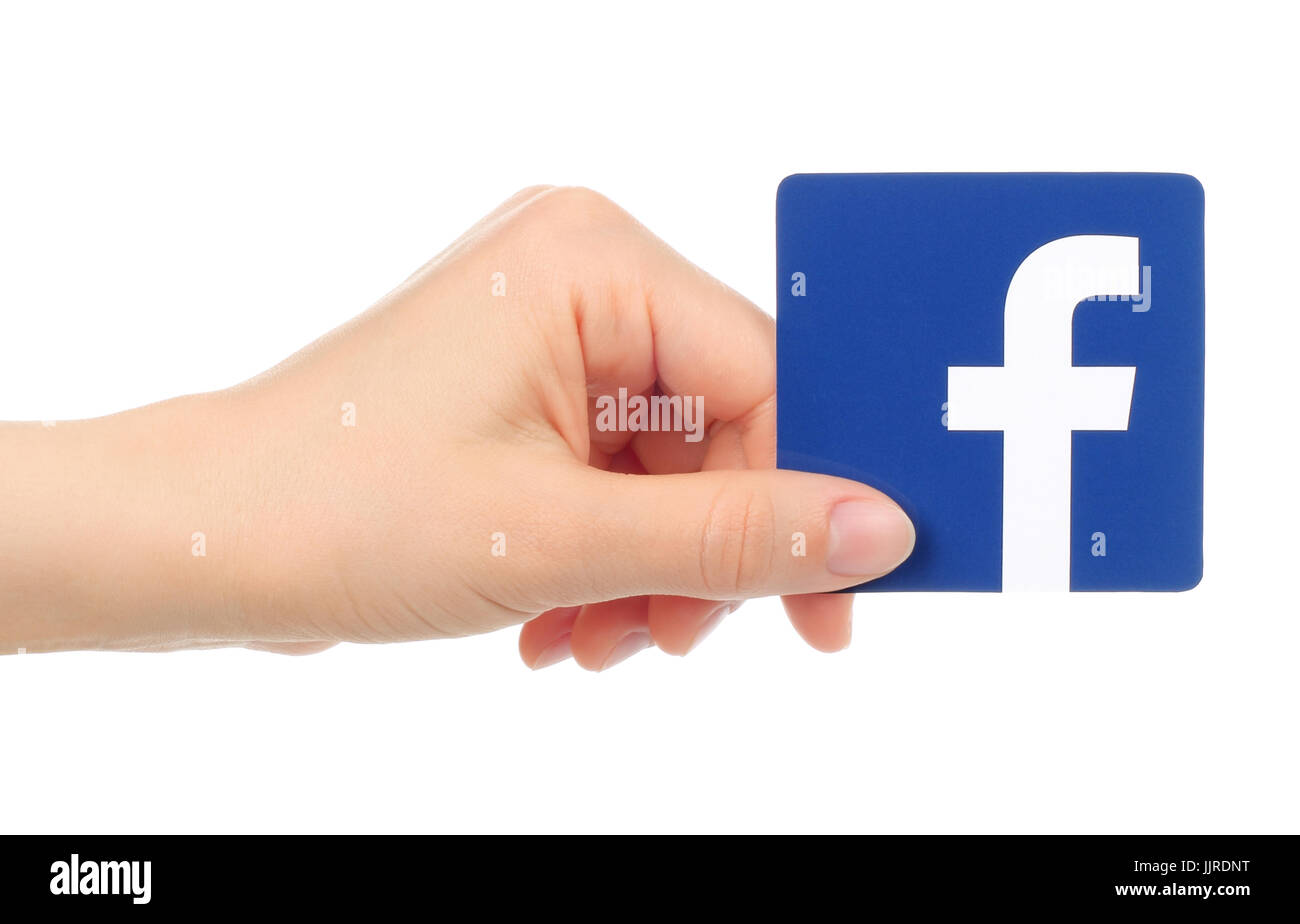 Kiev, Ukraine - May 17, 2016: Hand holds Facebook icon printed on paper ...