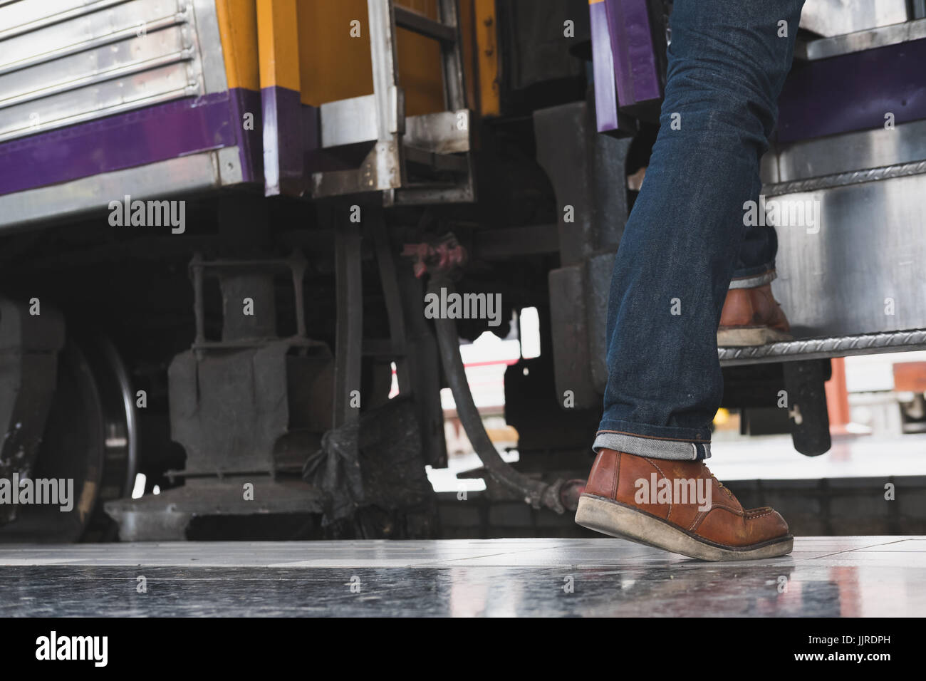 feet of young man, tourist or traveler stepping up to the train on ...