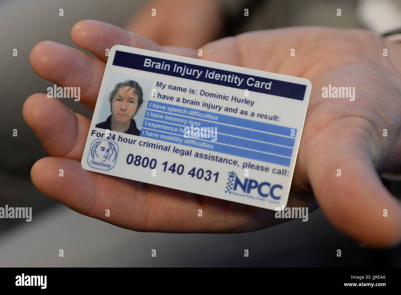 Brain injury survivor Dominic Hurley holds his Brain Injury Identity ...