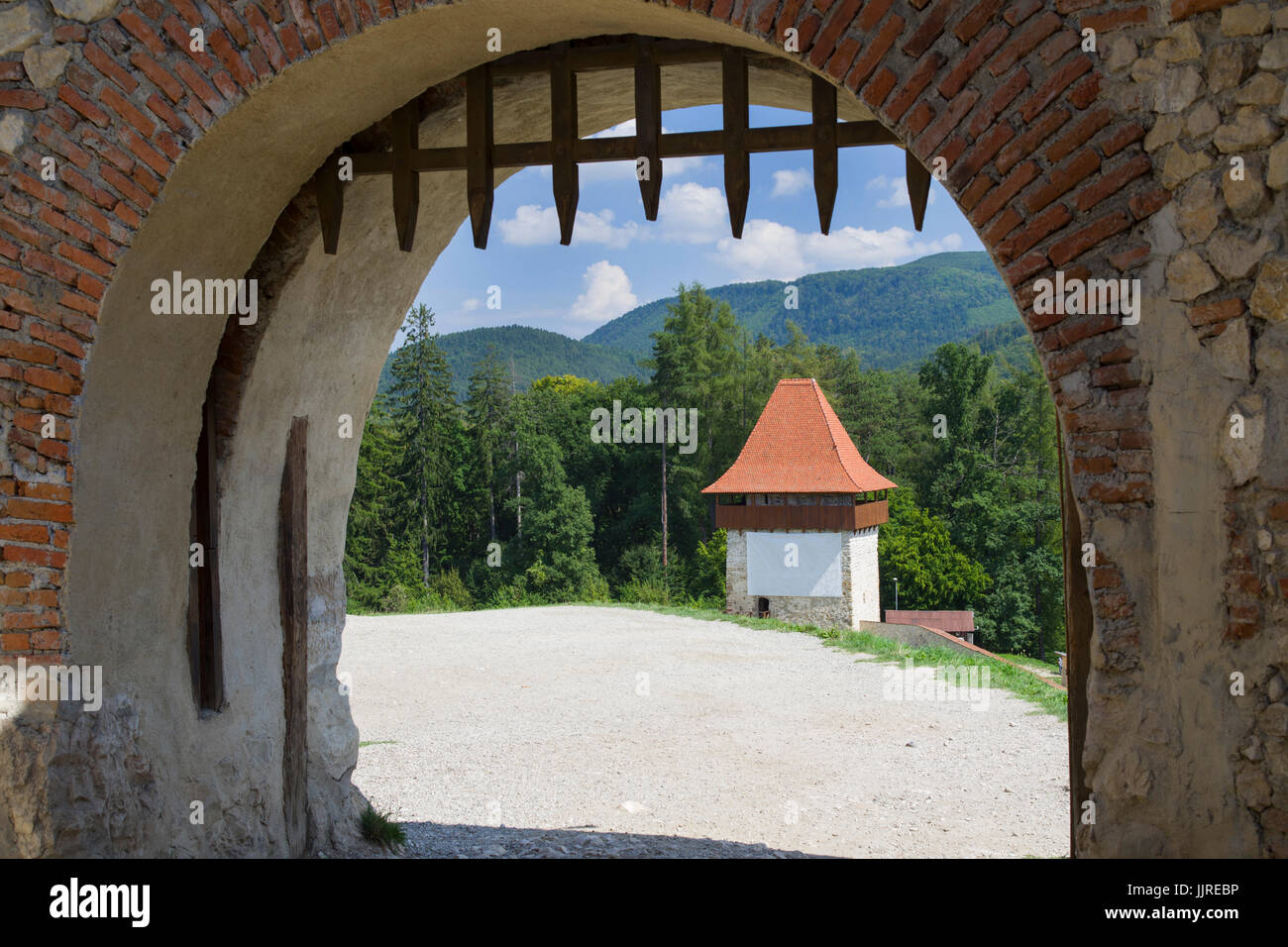 Old gate view in a stone fortress wall. Medieval fortress of Rasnov in ...