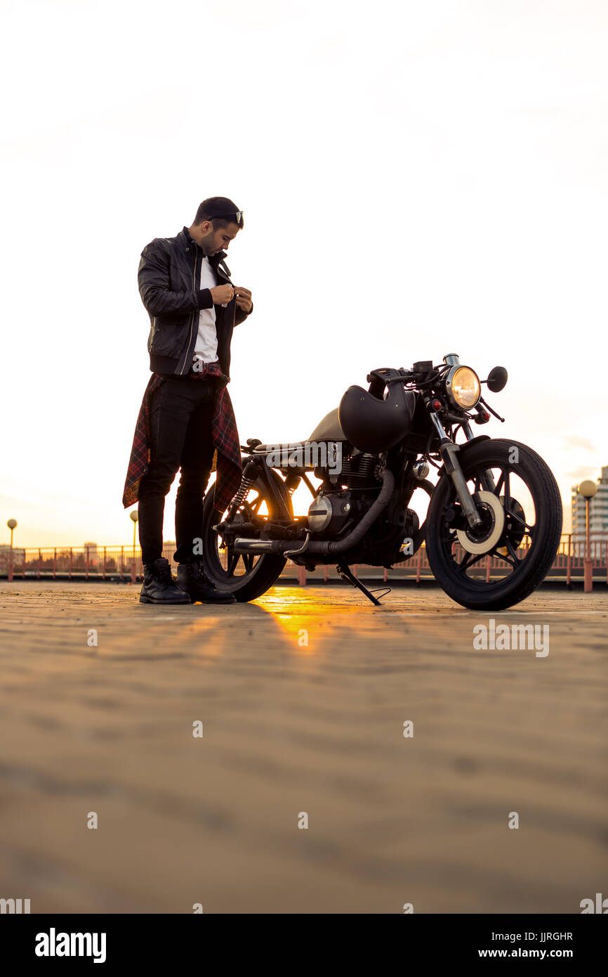 Handsome rider man with beard and mustache take something from black ...
