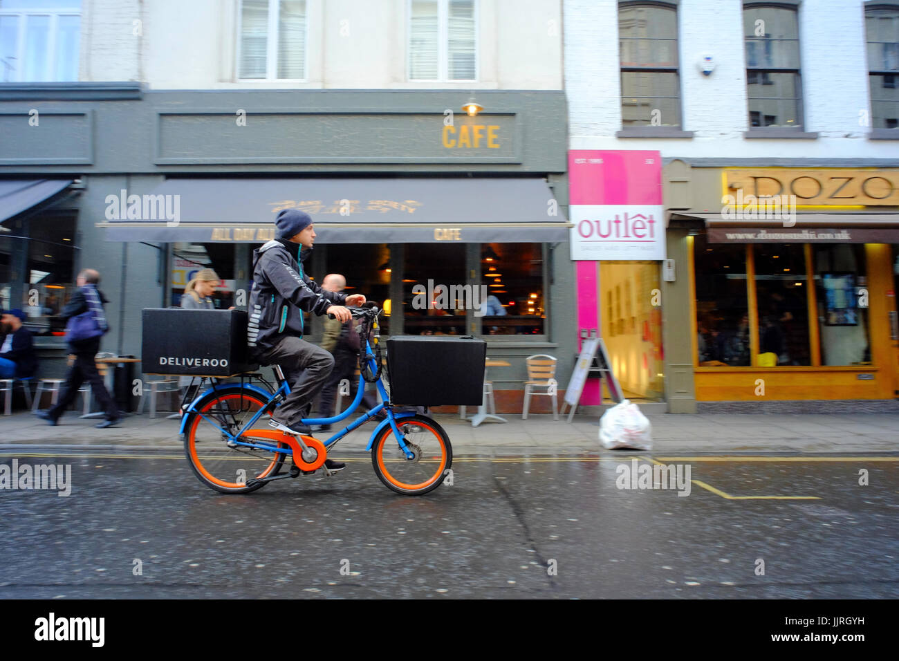 Deliveroo Rider in the rain in Soho, London, UK Stock Photo - Alamy