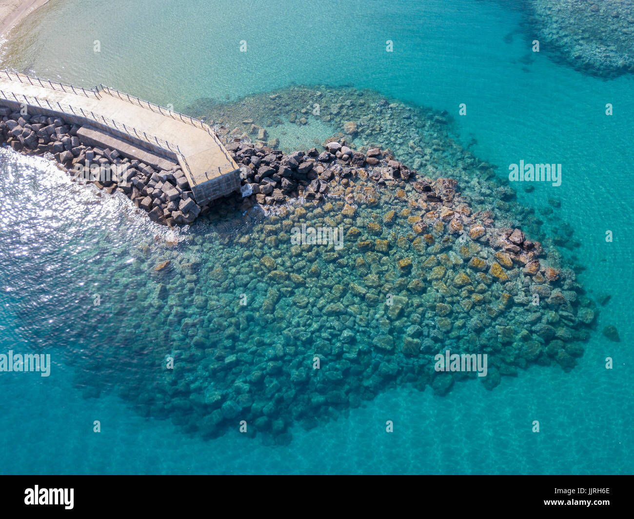 Aerial view of a pier with rocks and rocks on the sea. Pier of Pizzo ...