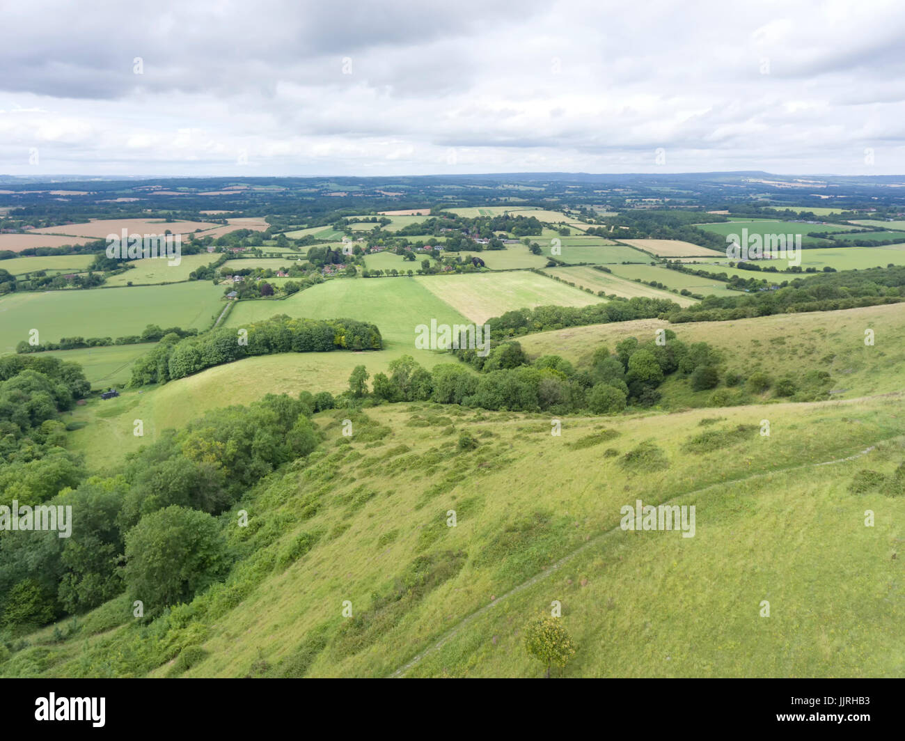 Aerial view of rolling hills, green farm fields, meadows, in south east ...