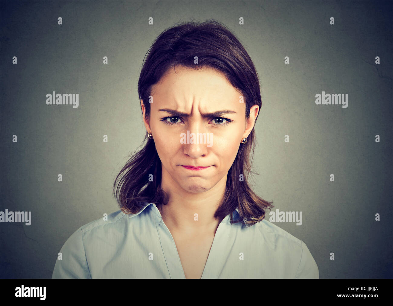 Angry young woman isolated on gray background. Negative human emotions ...