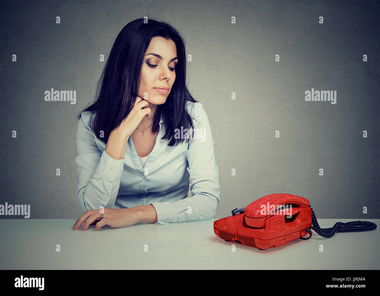 Portrait of a sad woman waiting for someone to call her Stock Photo - Alamy