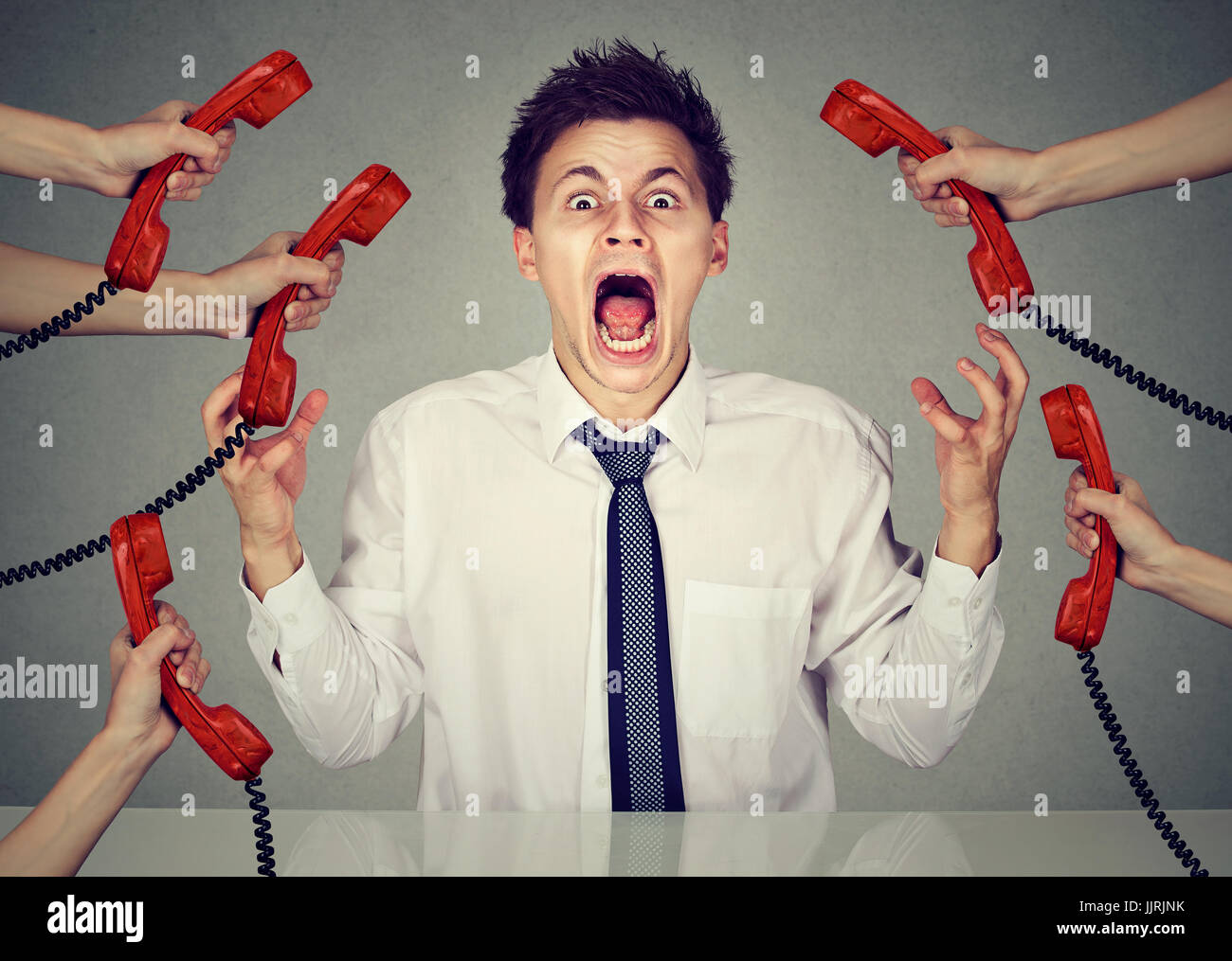 Business man stressed and nervous from to many work calls screaming in ...