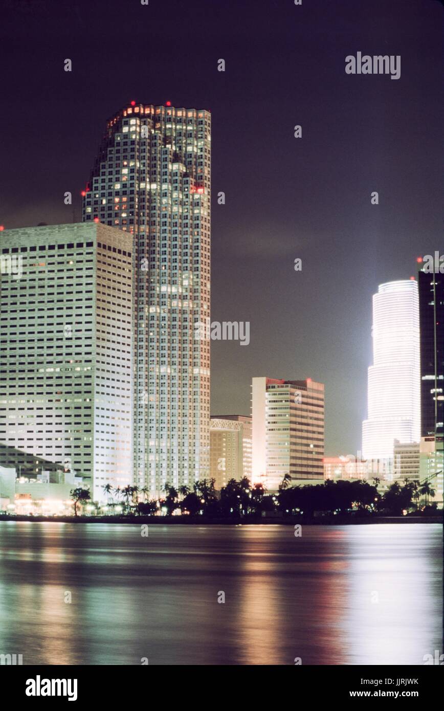 Buildings along the water at night with reflections, part of the ...