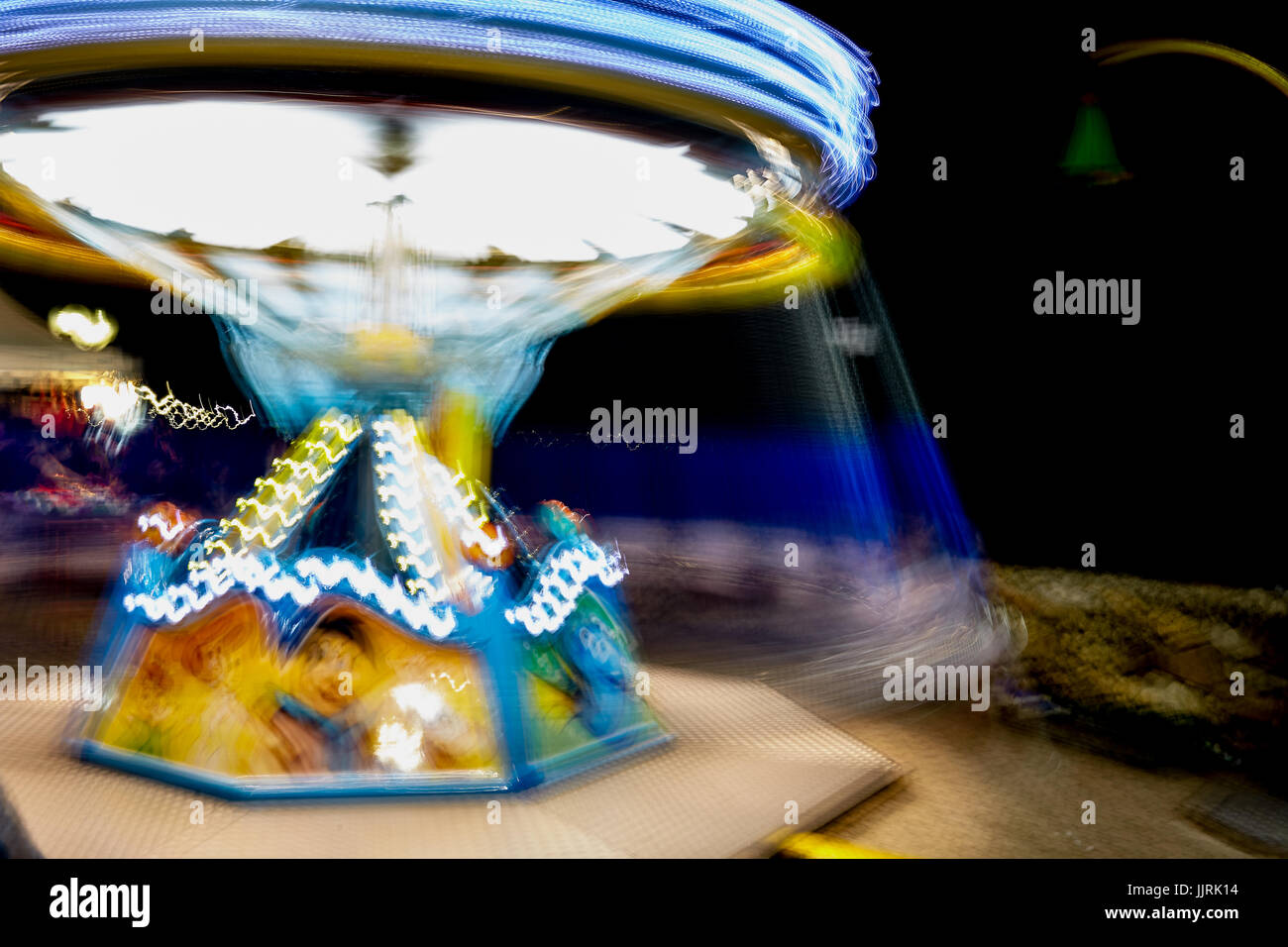 Long exposure of illuminated carousel in movement Stock Photo - Alamy