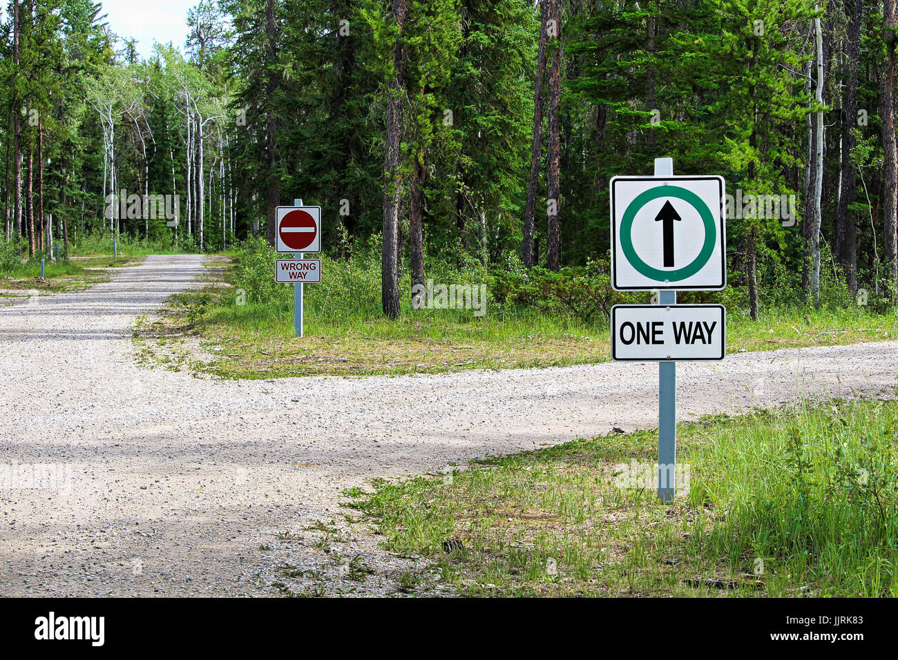 A one way and a wrong way sign by a country road intersection Stock ...