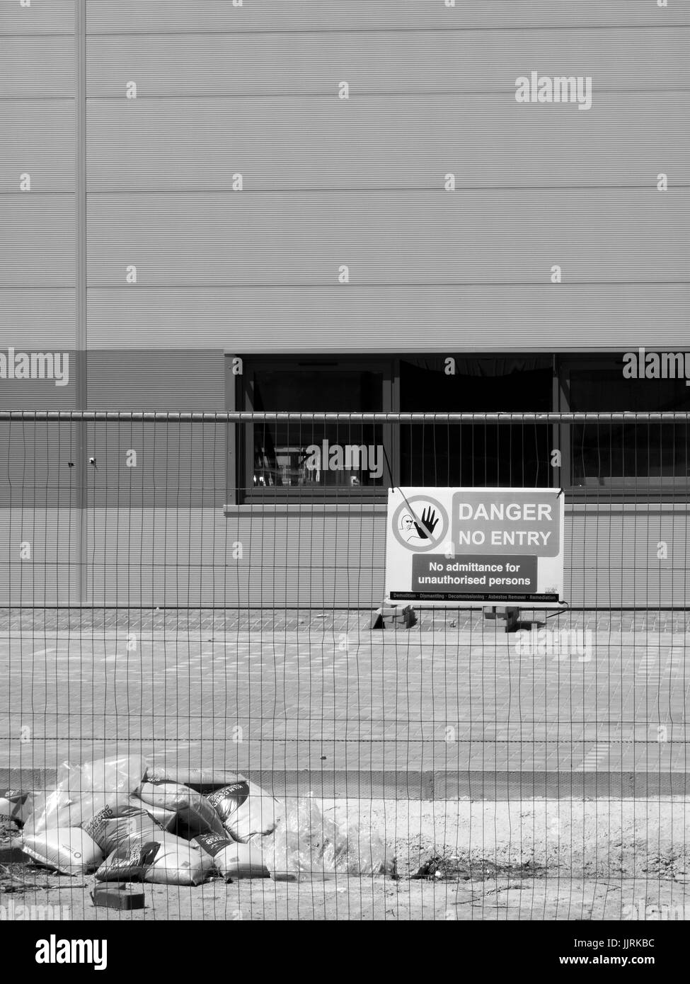 Danger no entry sign mounted on security fencing, new commercial ...