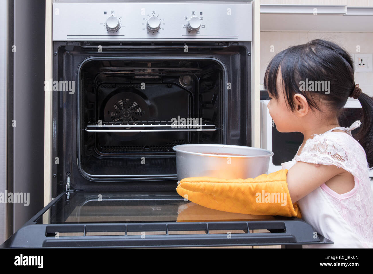 Asian Chinese little girl baking cake at home in the kitchen Stock ...