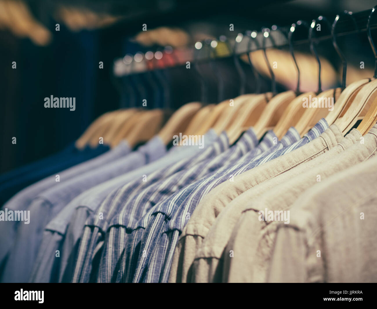 Close up view of man clothes hang in clothes store. Hangers with ...