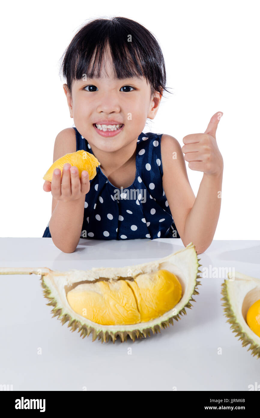 Asian Chinese little girl eating durian fruit in isolated white ...