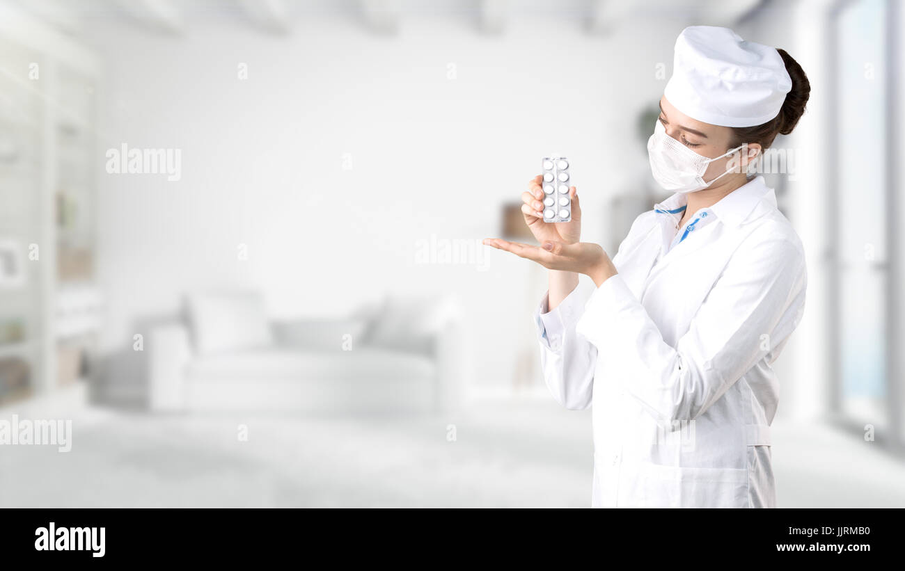 Beautiful medical woman doctor in uniform. Studio painted background ...