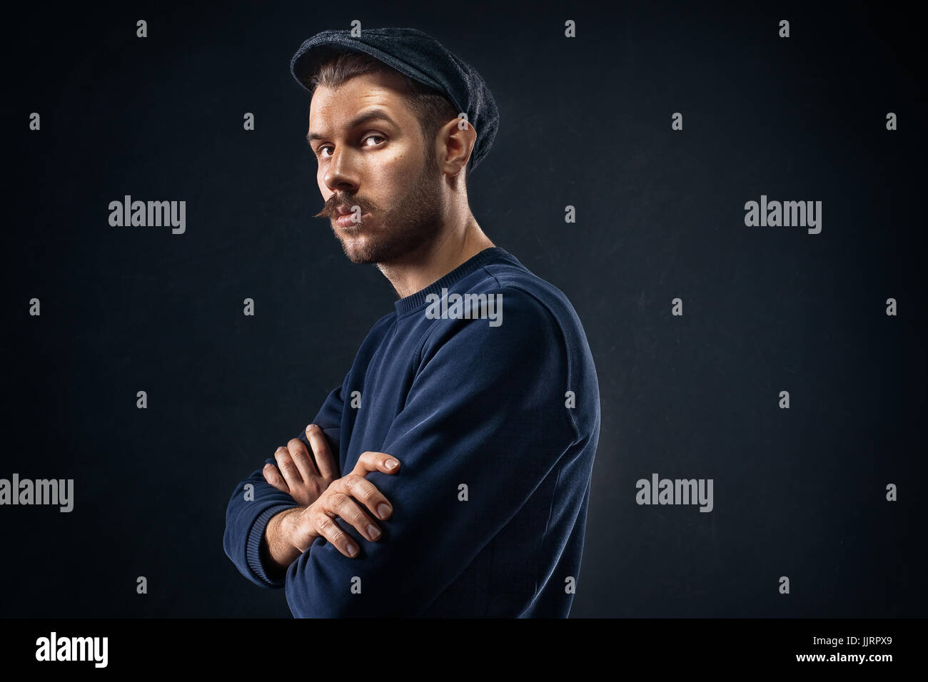 The young man in cap at studio Stock Photo - Alamy