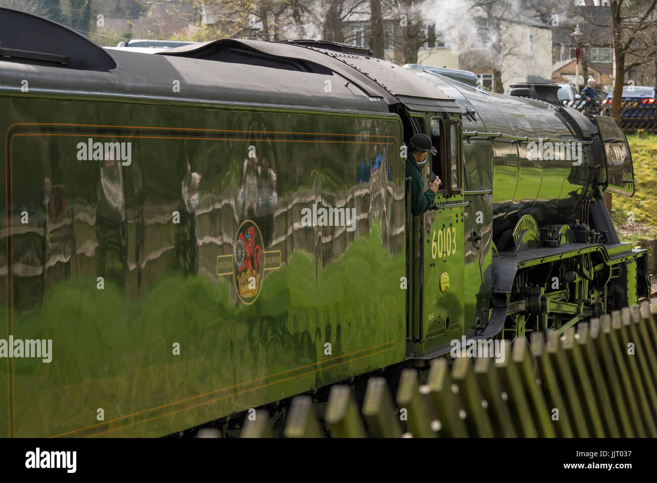 Driver in cab & fans reflected in green shiny engine of iconic steam ...