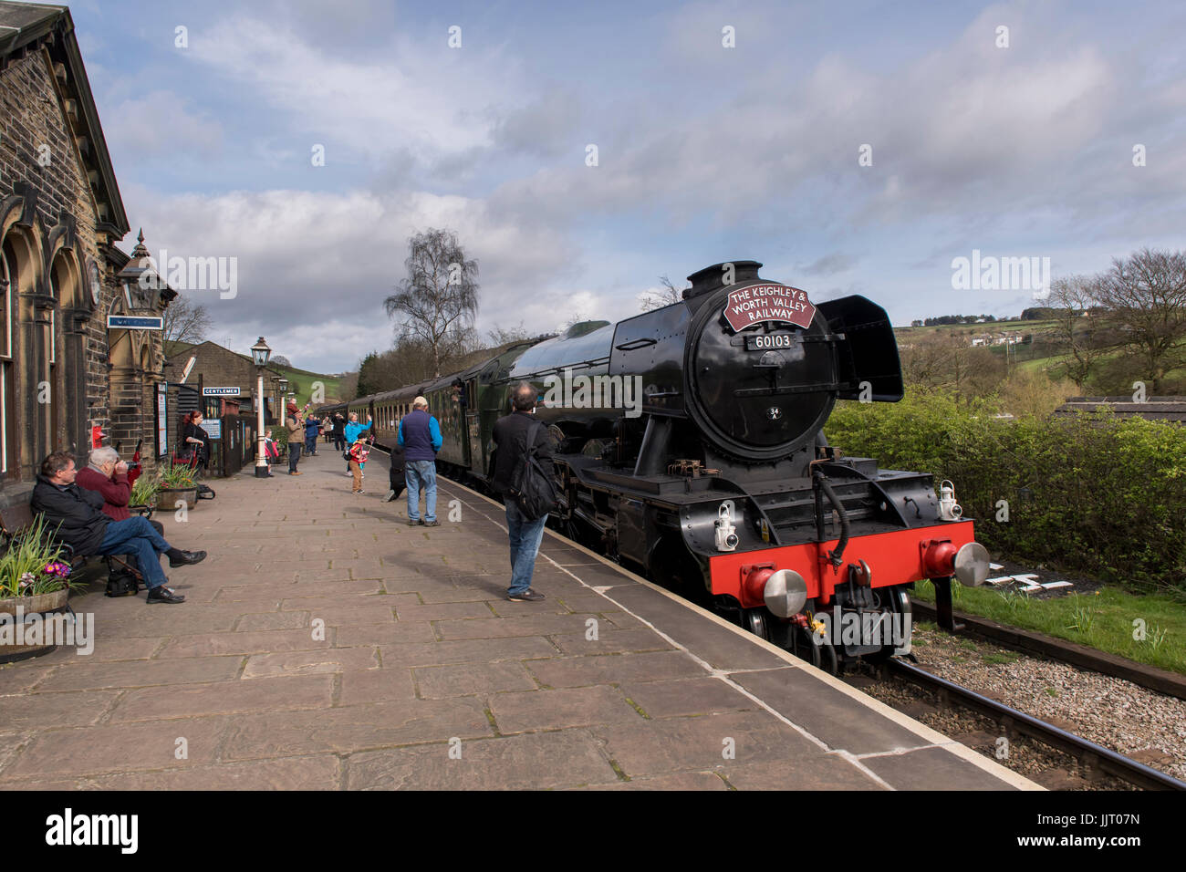 People on platform watch & wave at driver (iconic steam locomotive ...