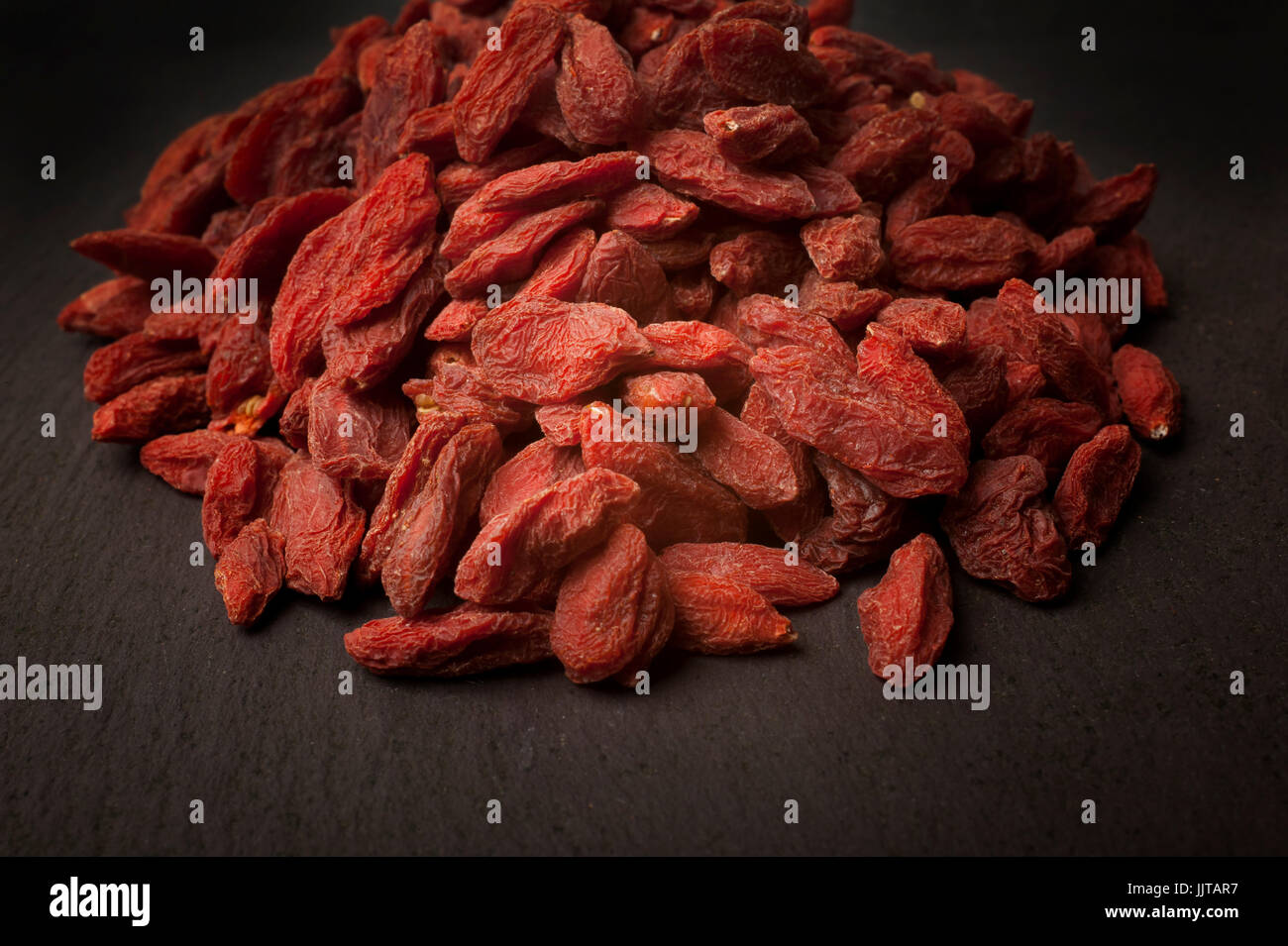 Dried Goji Lycium barbarum Berries on a slate worktop Stock Photo - Alamy