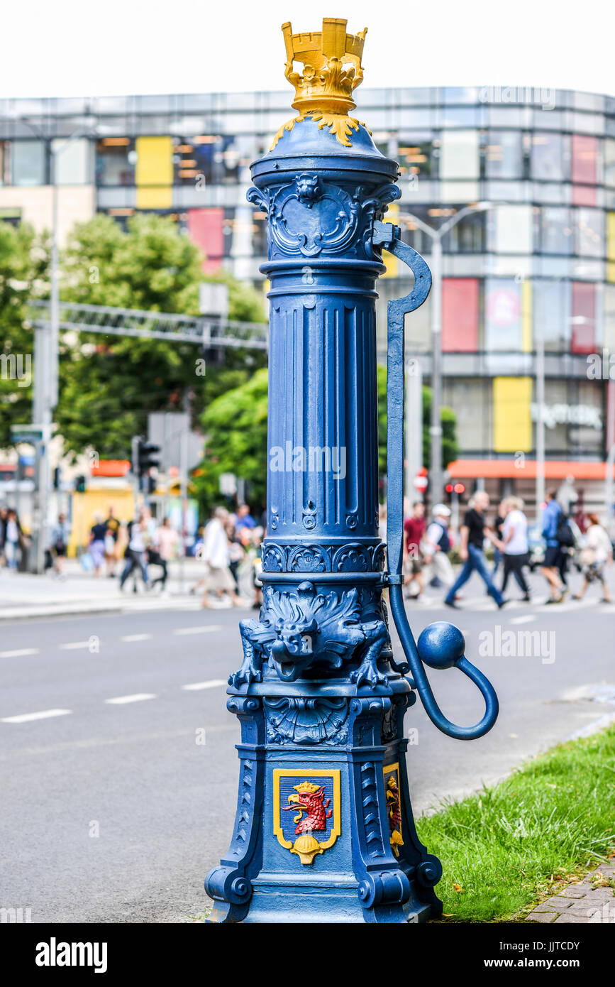 Old ancient blue pump of water with sculptures on it in Szczecin ...