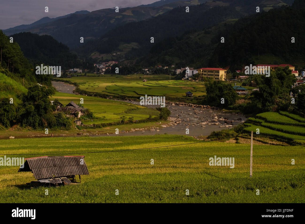 Terraced rice field with a mountain township at summer in Sapa, Vietnam ...