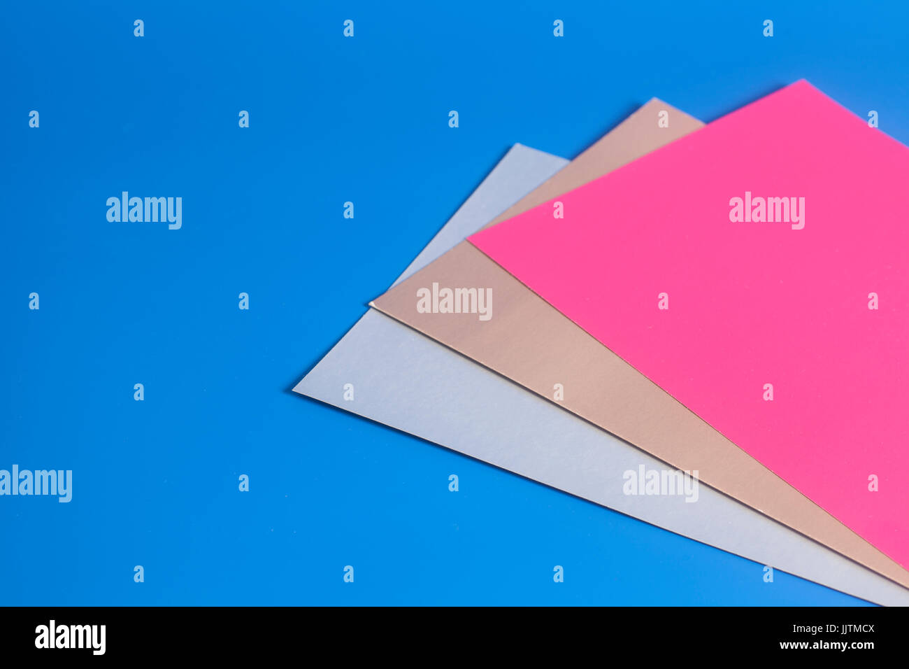 Colourful paper sheets on blue background Stock Photo - Alamy