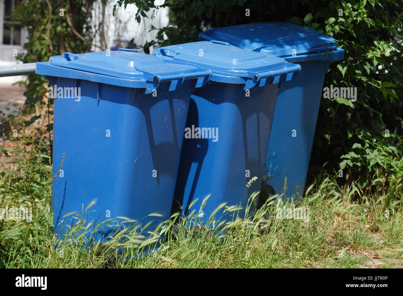 blue plastic reciyling bins for waste paper Stock Photo - Alamy