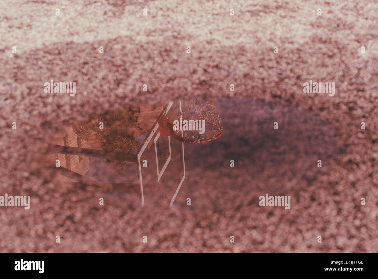 Reflection of basketball hoop in the puddle on sport playground Stock ...