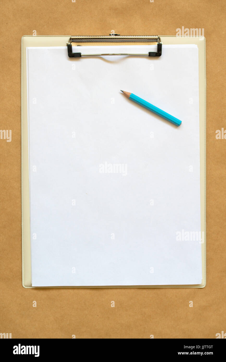 Pencil, clipboard and note paper as copy space for business project ...
