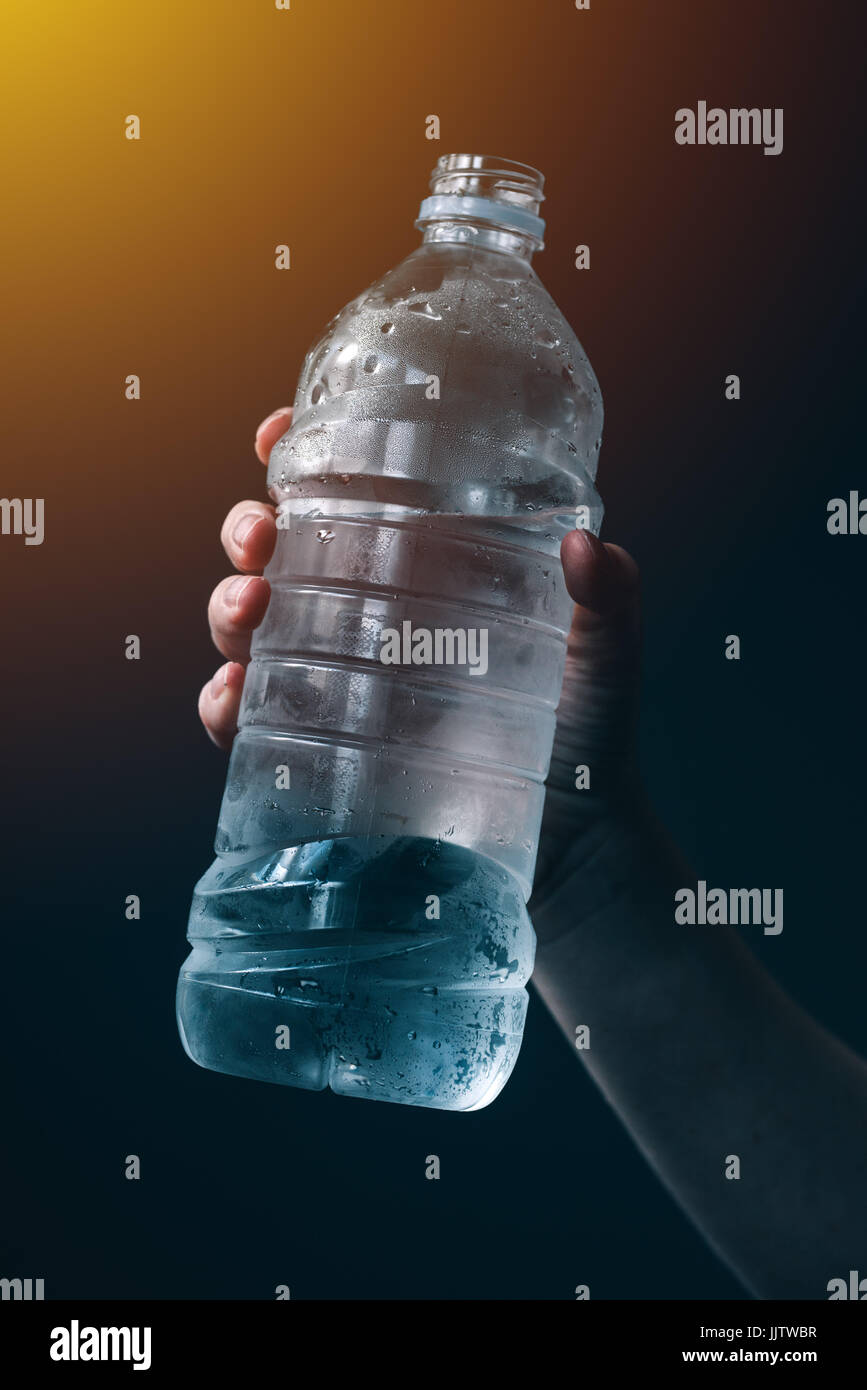 Female hand with bottle of fresh water, selective focus Stock Photo - Alamy