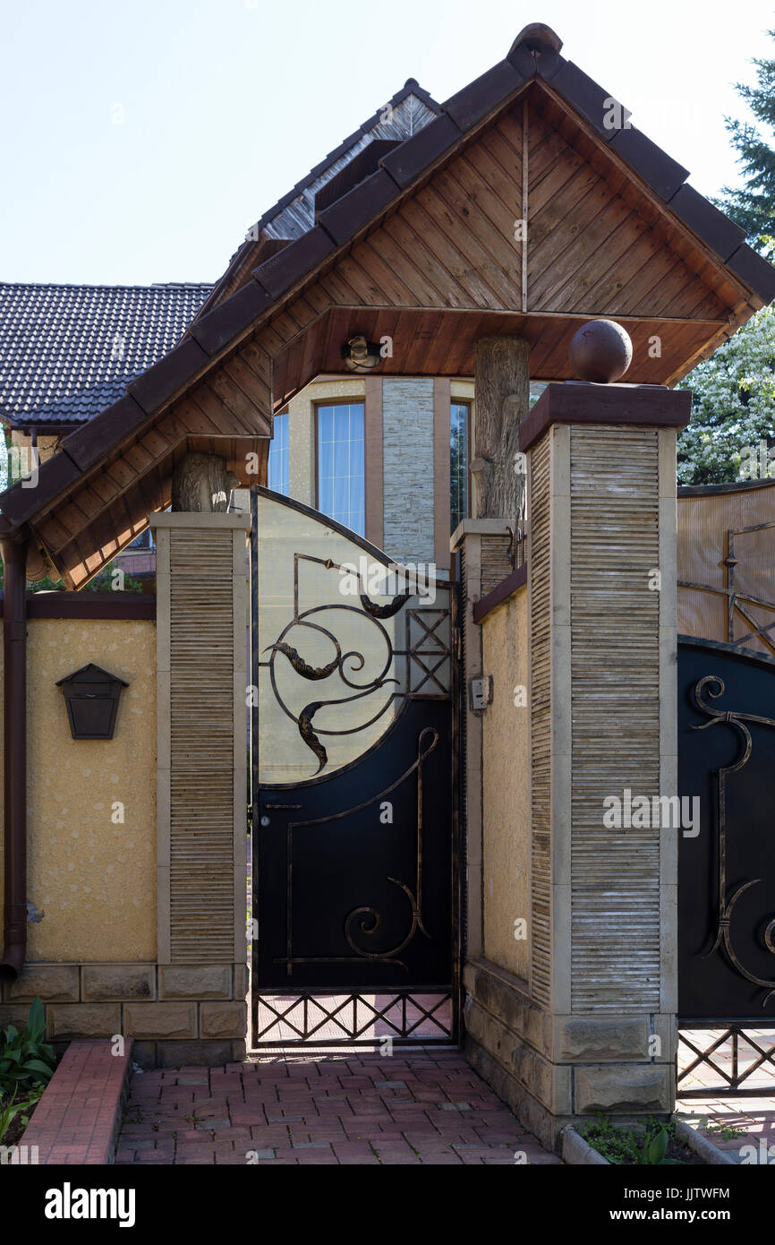 Beautiful metal door. The gateway to an yard Stock Photo - Alamy
