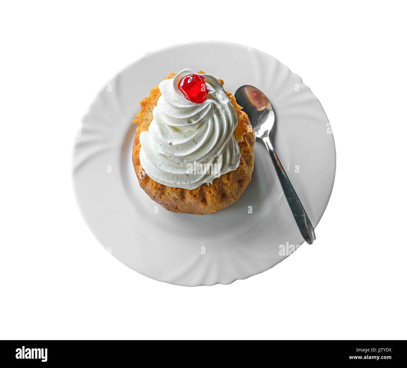 Savarin cake with cream and syrup, silver spoon, white plate isolated ...