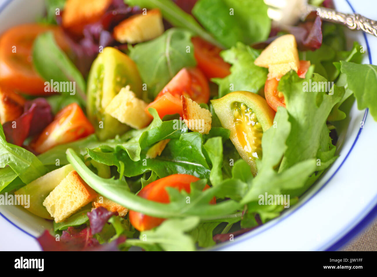 Mixed greens salad with miniature heirloom tomatoes and croutons Stock ...