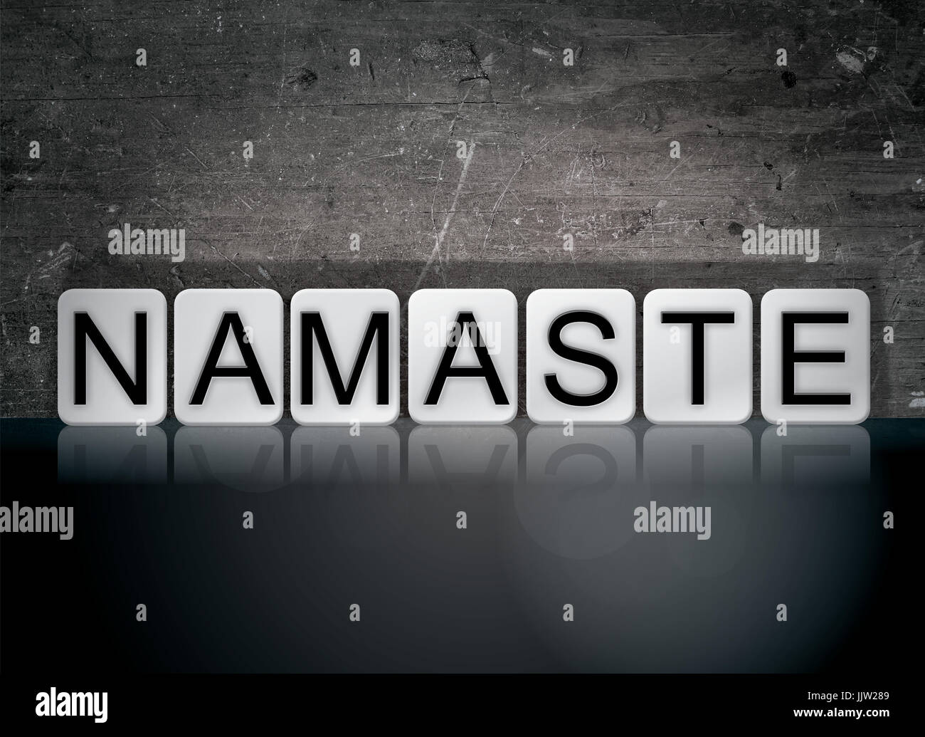 The word Namaste concept and theme written in white tiles on a dark ...