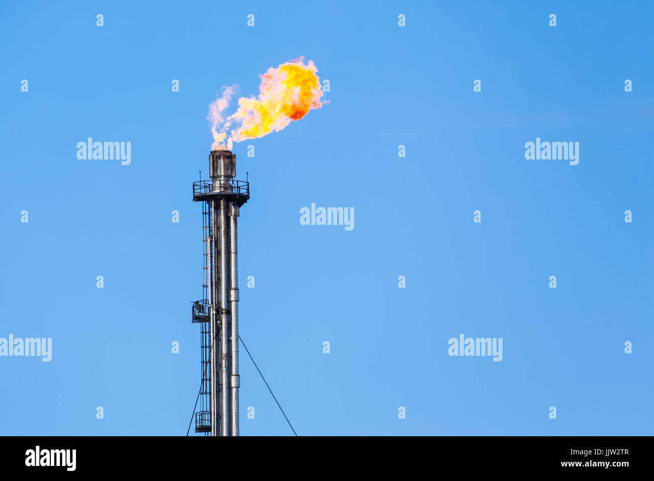 Torches for casing-head gas flaring during oil production Stock Photo ...