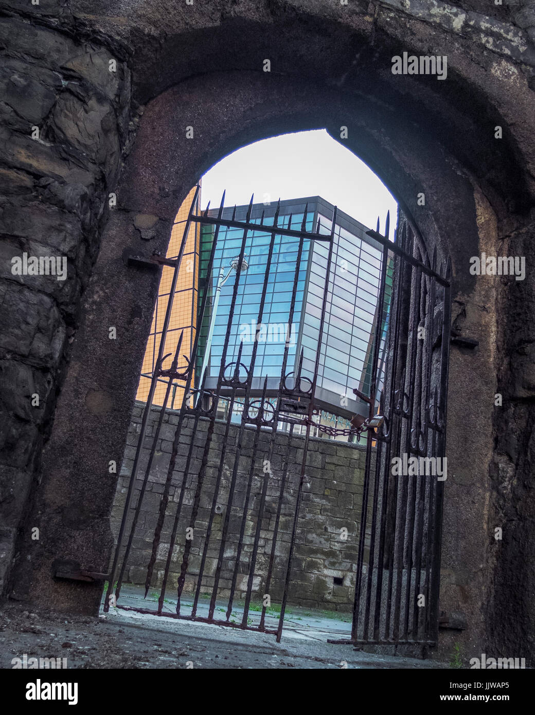 Looking through gateway of old building to modern architecture Stock ...
